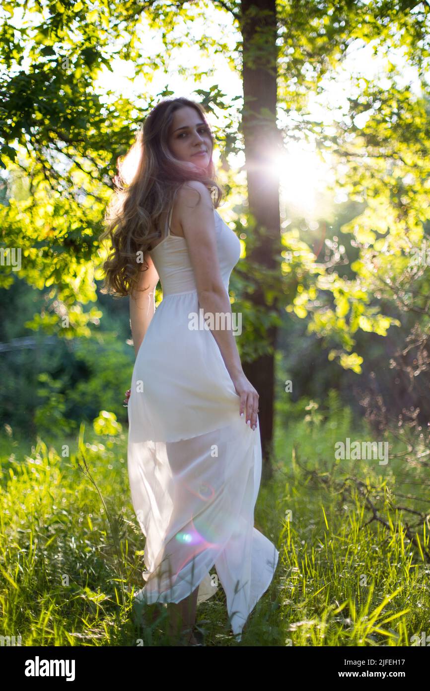 Beautiful Young Russian Girl Dressed In A White Dress Walks Through