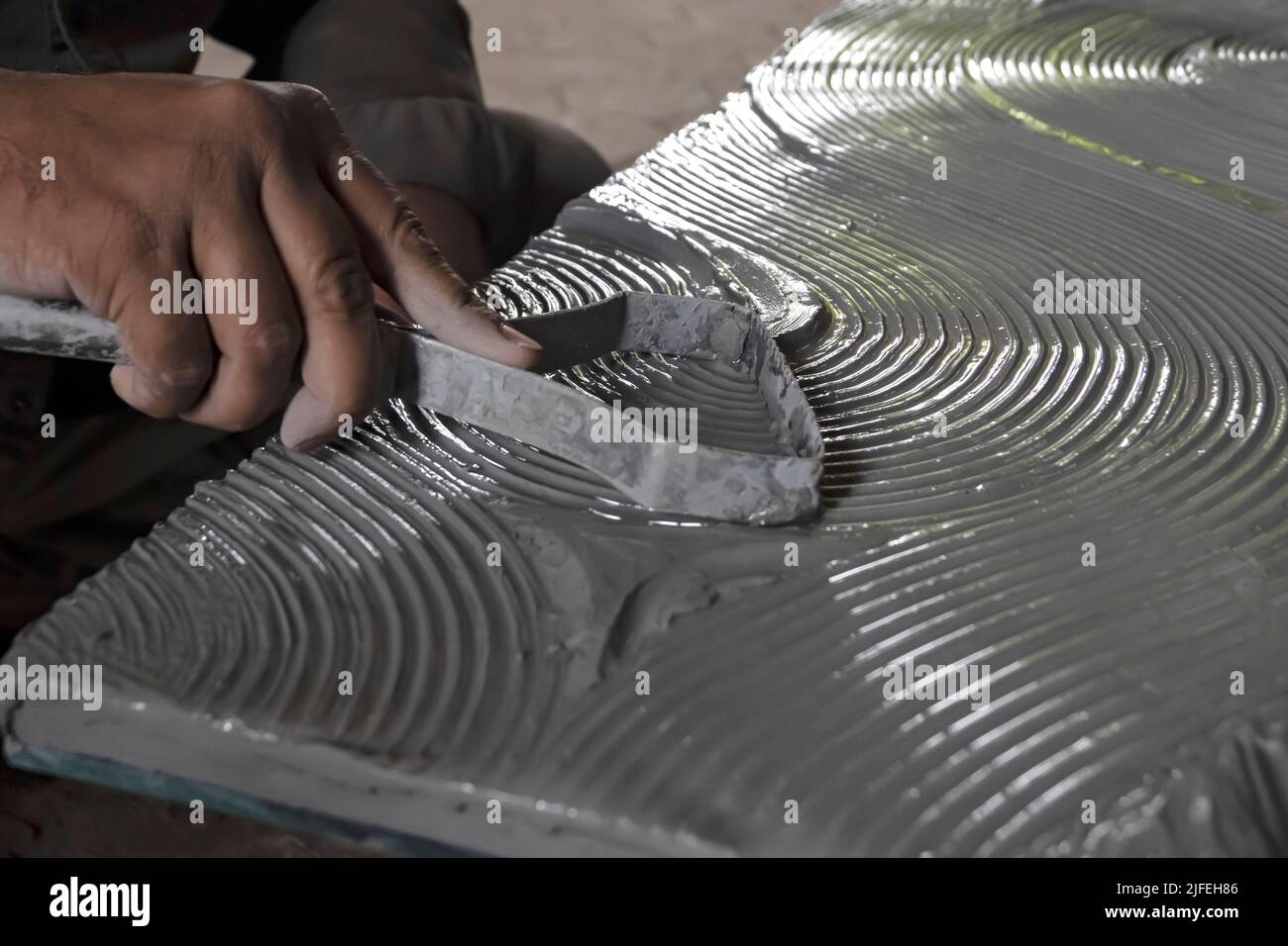 Close up of male sculptor holding tool and making art on clay. Clay ...