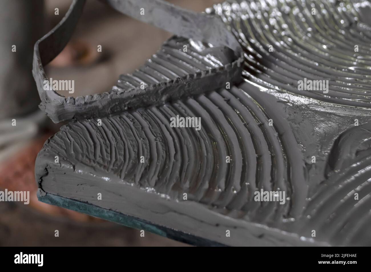 Close up of male sculptor holding tool and making art on clay. Clay ...