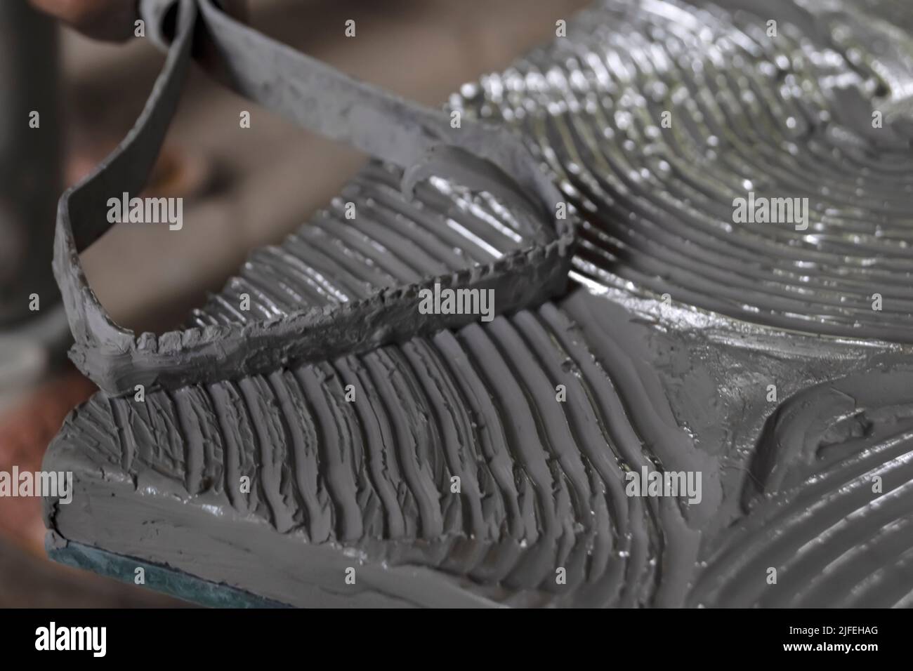 Close up of male sculptor holding tool and making art on clay. Clay ...