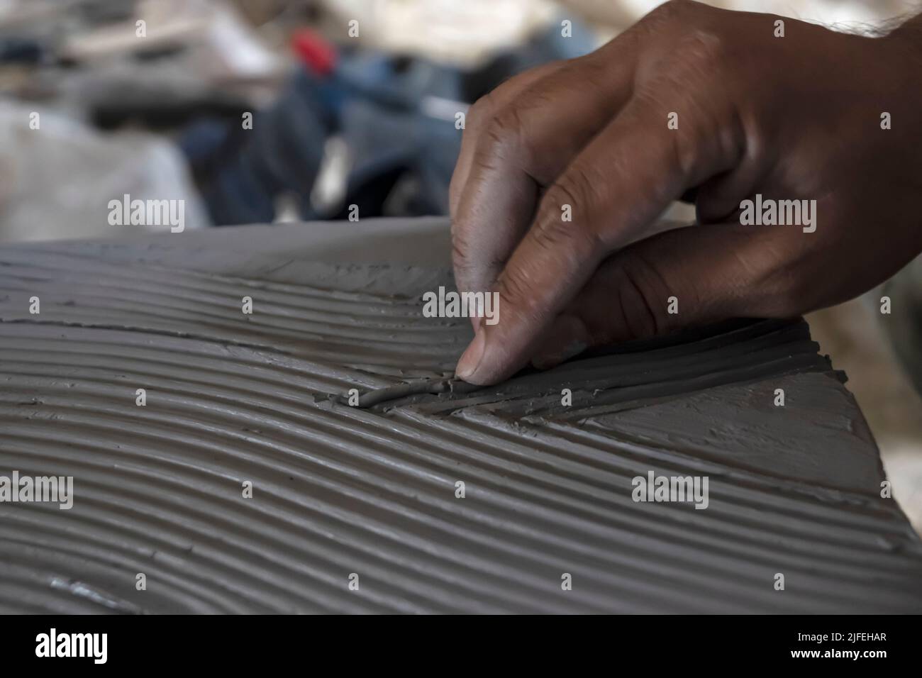 Close up of male sculptor making art on clay using hands. Clay master ...