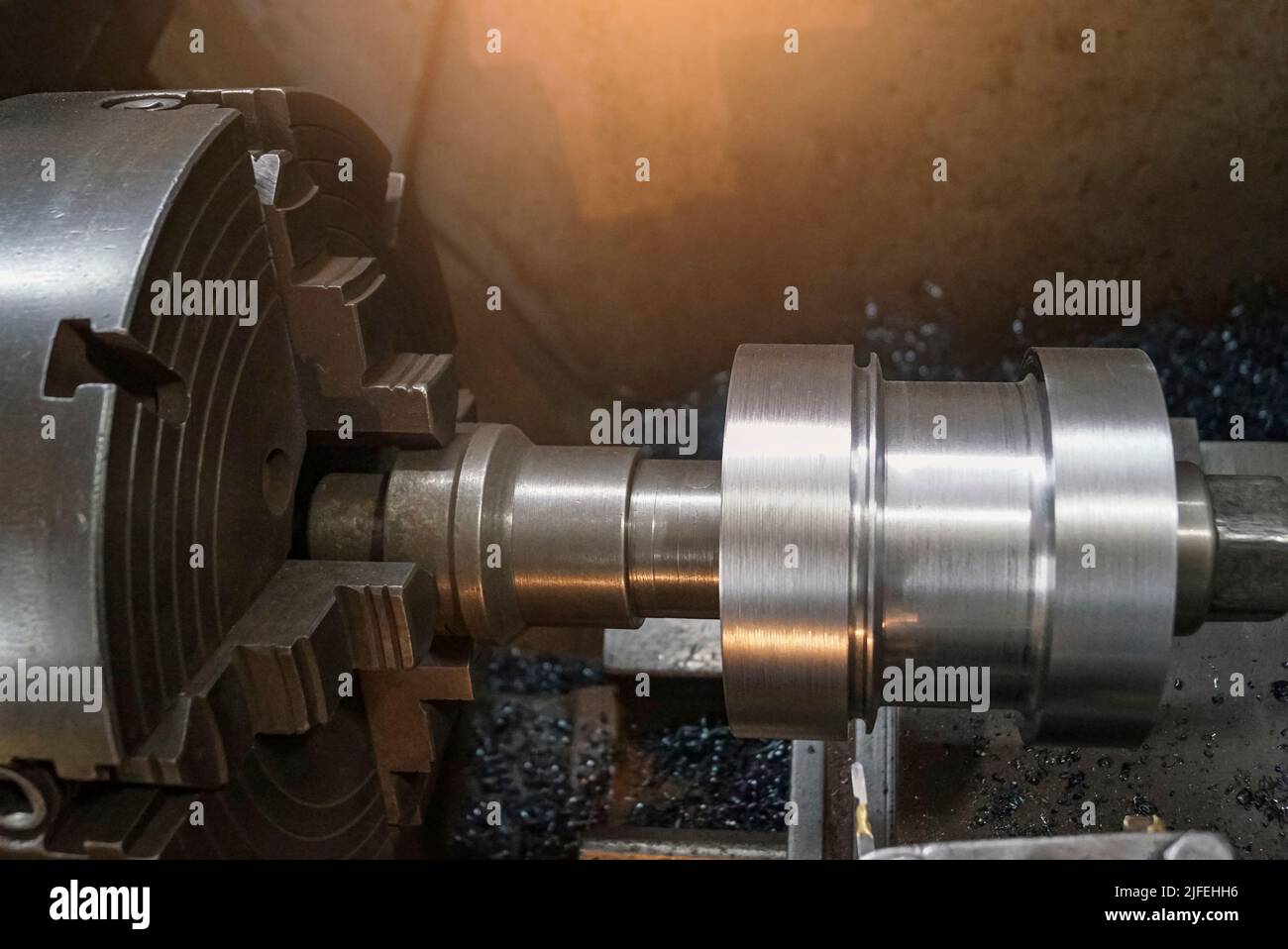 Closeup of a metal shaft parts cutting by old Lathe Machinery. lathe ...