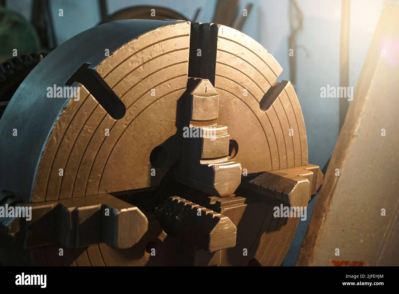 Closeup of an old Lathe Machinery. lathe chuck and key 4-jaw screw ...