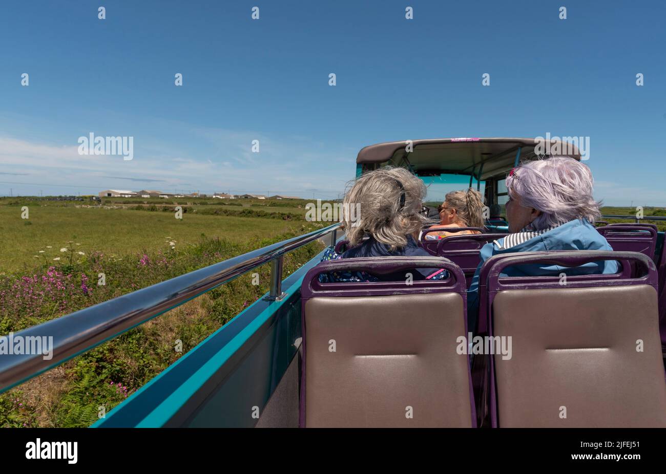 Cornwall, England, UK. 2022. Passengers travelling on a open top ...