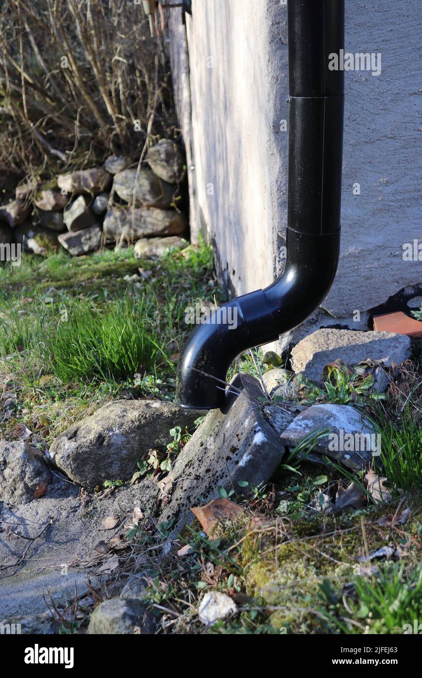 A vertical shot of a gutter Downspout on a wall Stock Photo - Alamy
