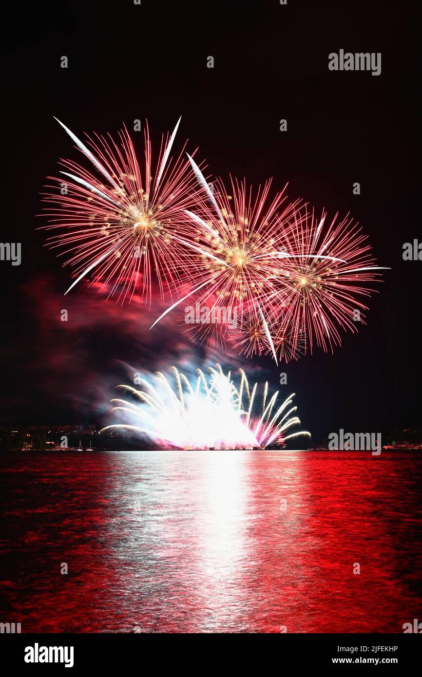 Beautiful colorful fireworks over the water. International fireworks ...