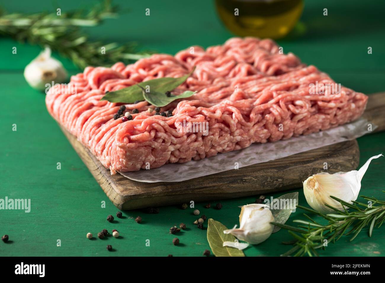 Raw Mince, minced Ground beef meat on a cutting board. Green background ...