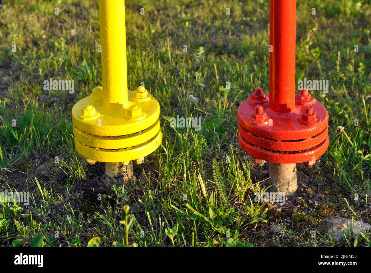 Yellow gas and fire red pipe with coupling Stock Photo - Alamy