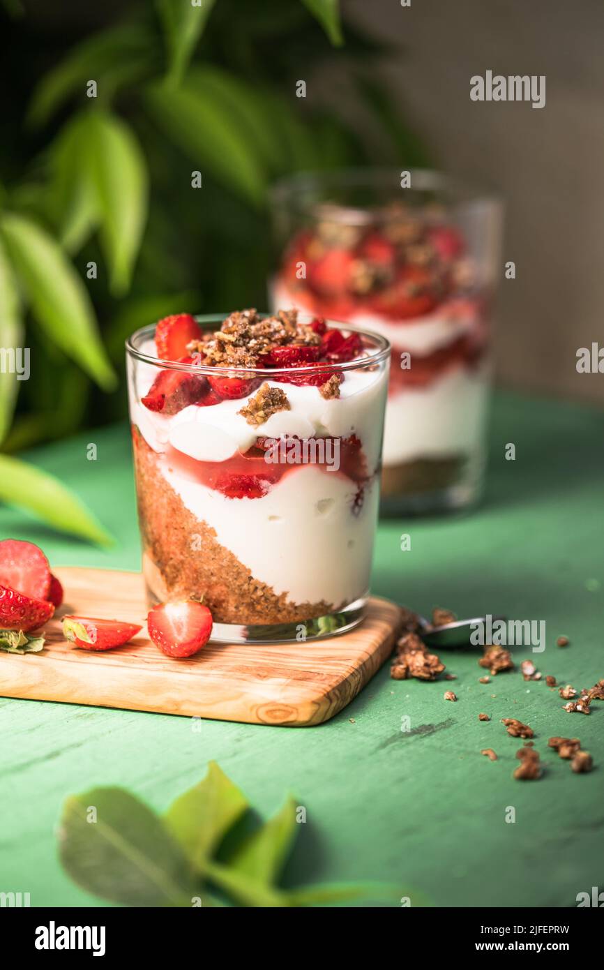 Breakfast layered parfait dessert with yogurt, sponge biscuit and fresh ...