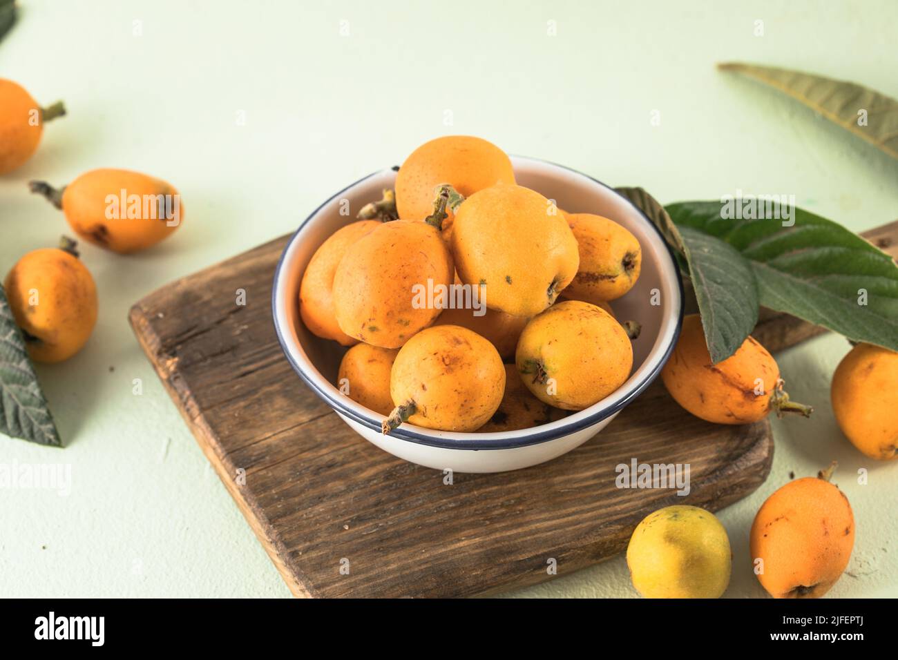 Ripe medlar fruit , Eriobotrya japonica, and green medlar leaves on ...
