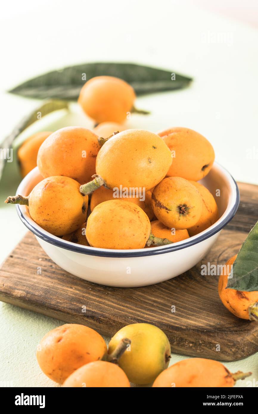 Ripe medlar fruit , Eriobotrya japonica, and green medlar leaves on ...