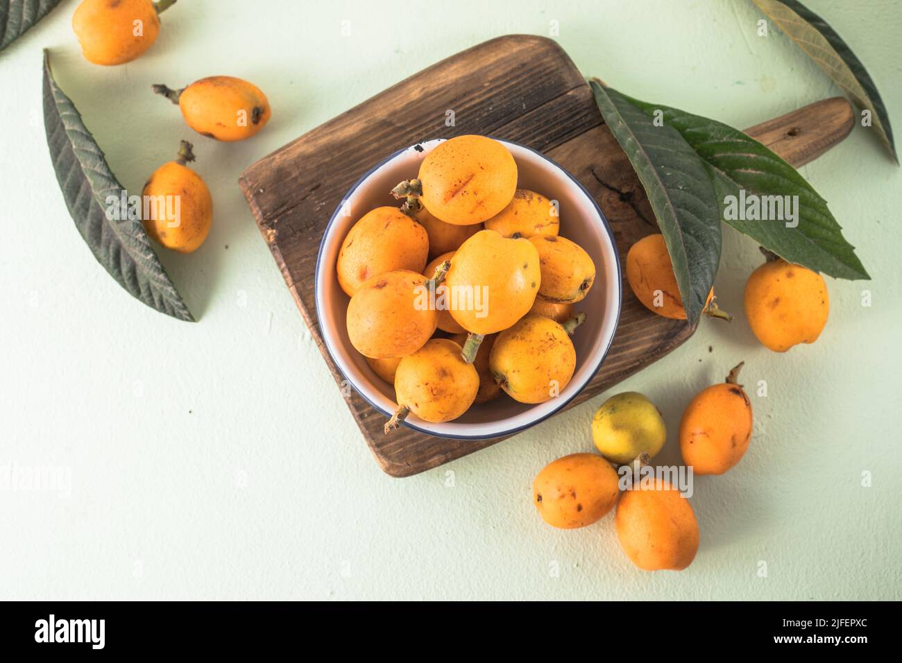 Ripe medlar fruit , Eriobotrya japonica, and green medlar leaves on ...