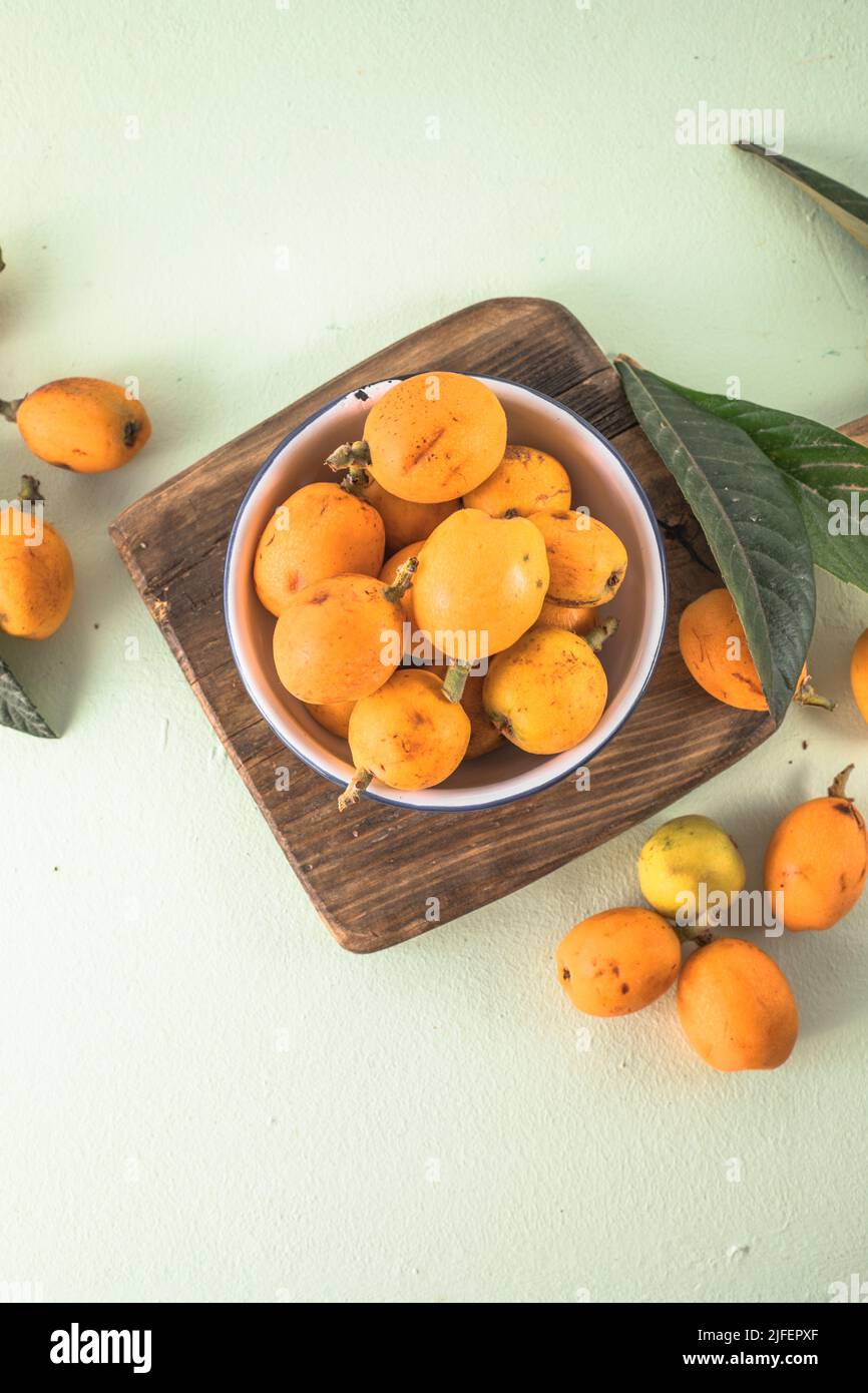 Ripe medlar fruit , Eriobotrya japonica, and green medlar leaves on ...