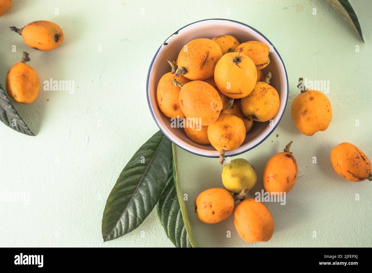 Ripe medlar fruit , Eriobotrya japonica, and green medlar leaves on ...