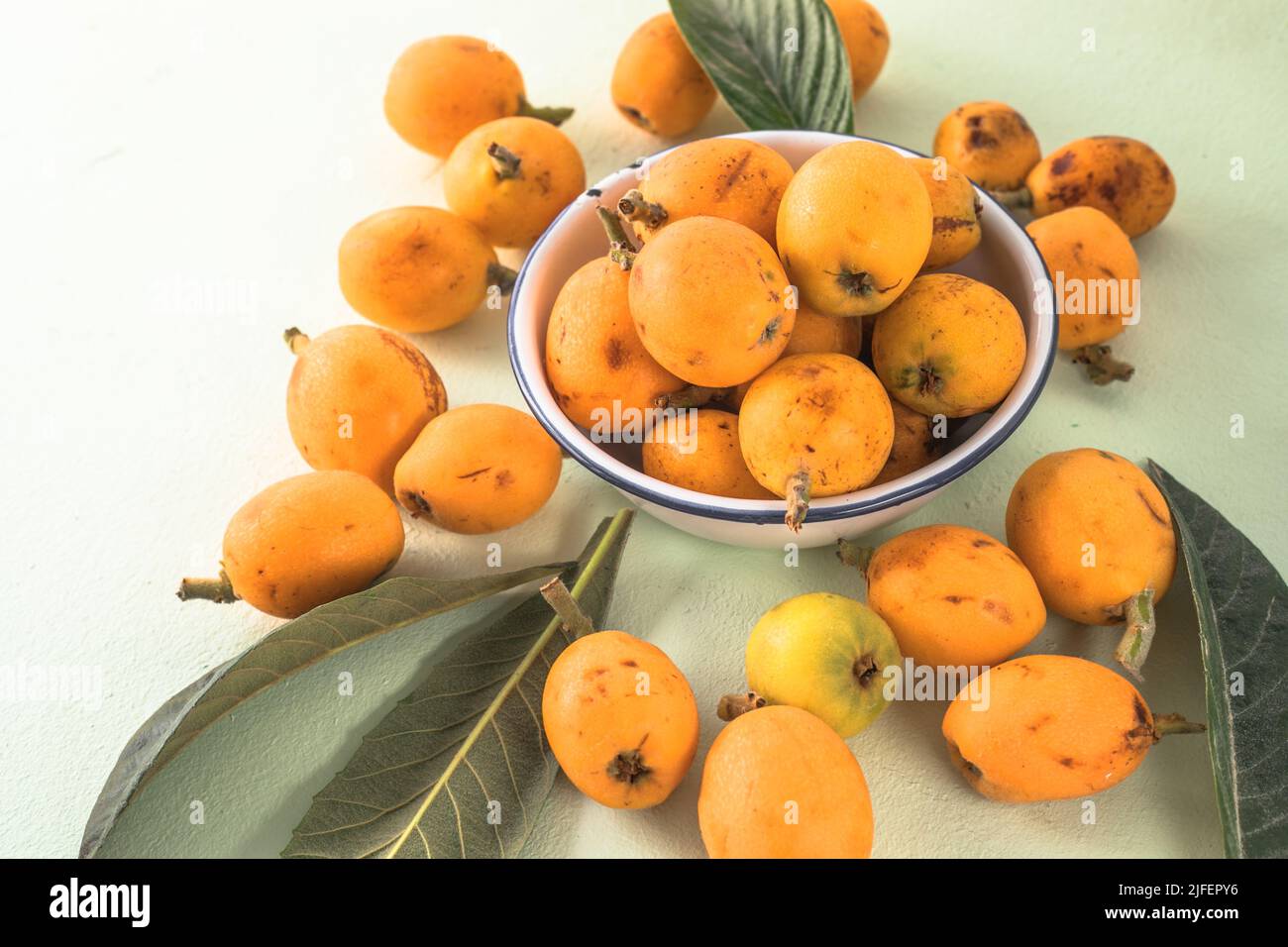 Ripe medlar fruit , Eriobotrya japonica, and green medlar leaves on ...