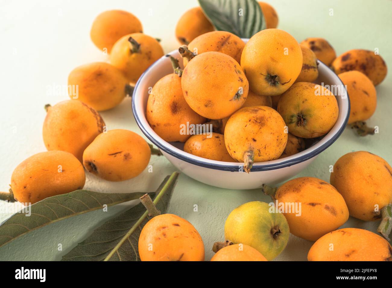 Ripe medlar fruit , Eriobotrya japonica, and green medlar leaves on ...