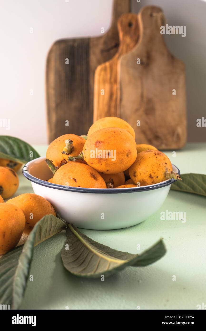 Ripe medlar fruit , Eriobotrya japonica, and green medlar leaves on ...