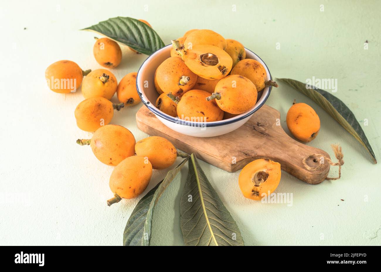 Ripe medlar fruit , Eriobotrya japonica, and green medlar leaves on ...
