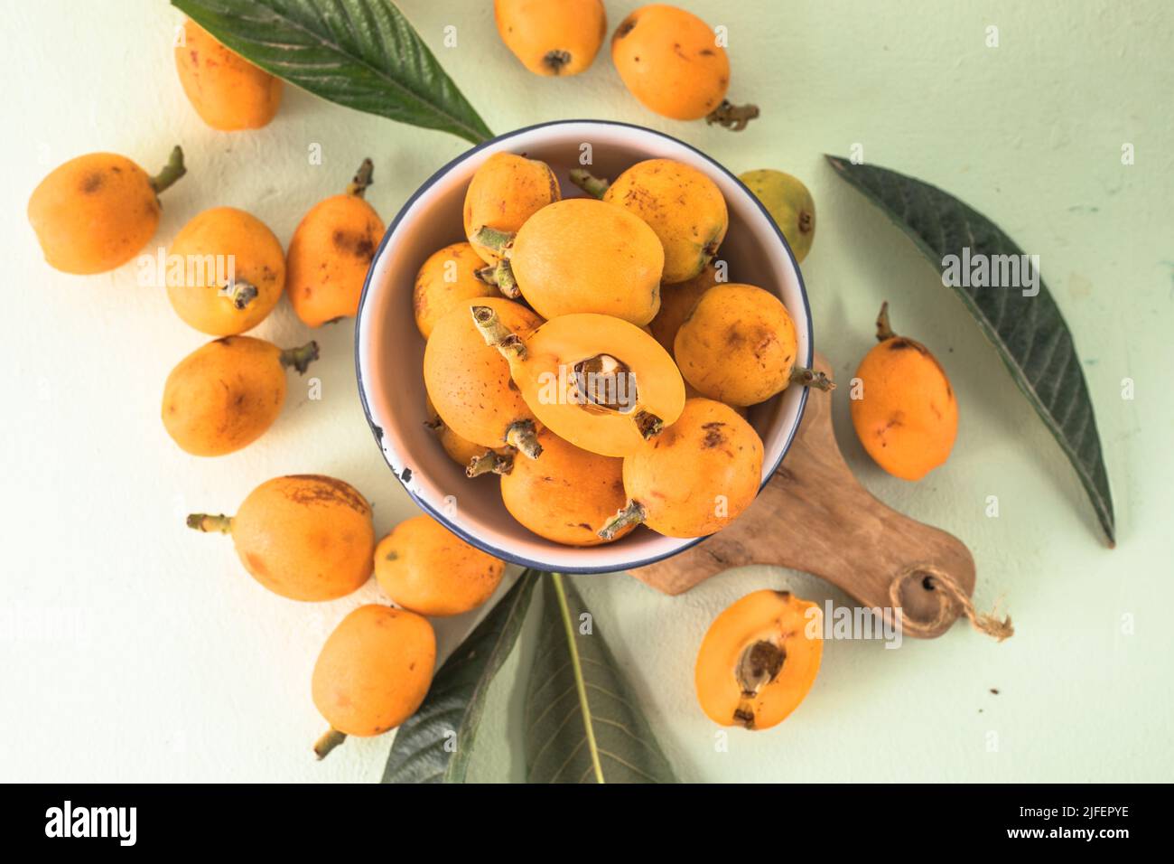 Ripe medlar fruit , Eriobotrya japonica, and green medlar leaves on ...