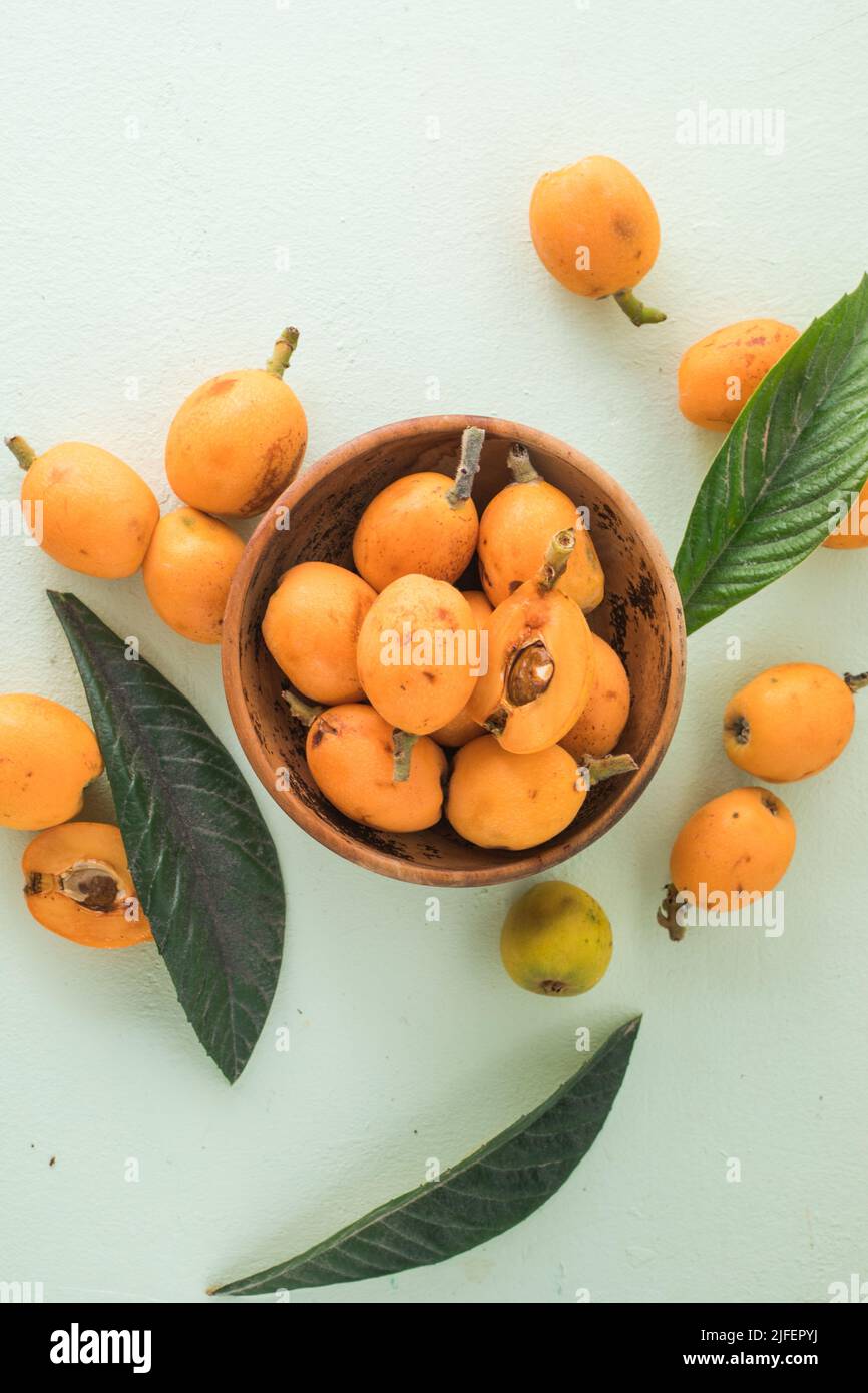 Ripe medlar fruit , Eriobotrya japonica, and green medlar leaves on ...