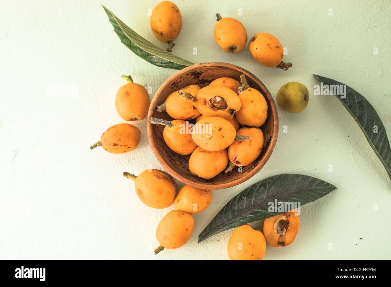 Ripe medlar fruit , Eriobotrya japonica, and green medlar leaves on ...