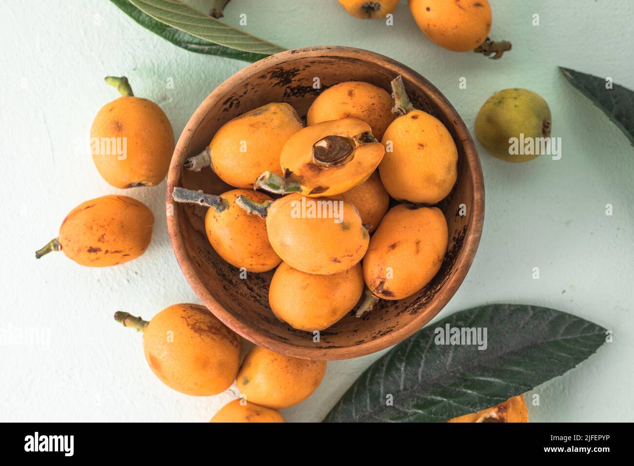 Ripe medlar fruit , Eriobotrya japonica, and green medlar leaves on ...