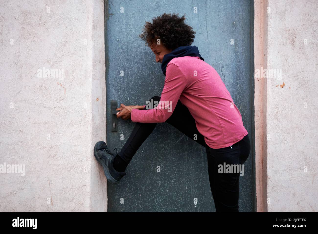 A view of a happy African-American female holding the handle and trying ...