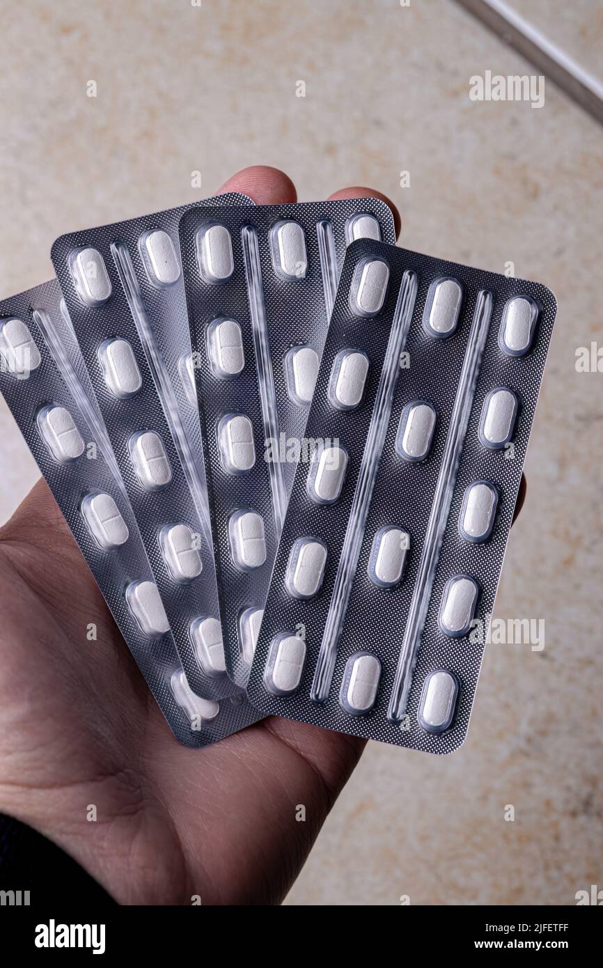 metallic medicine blister packs with white pills Stock Photo - Alamy