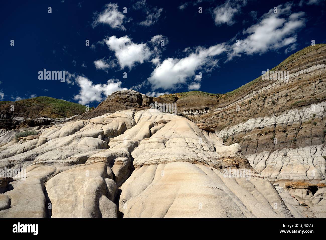 Tourist woman standing on a sandstone and photographing the Hoodoos and ...