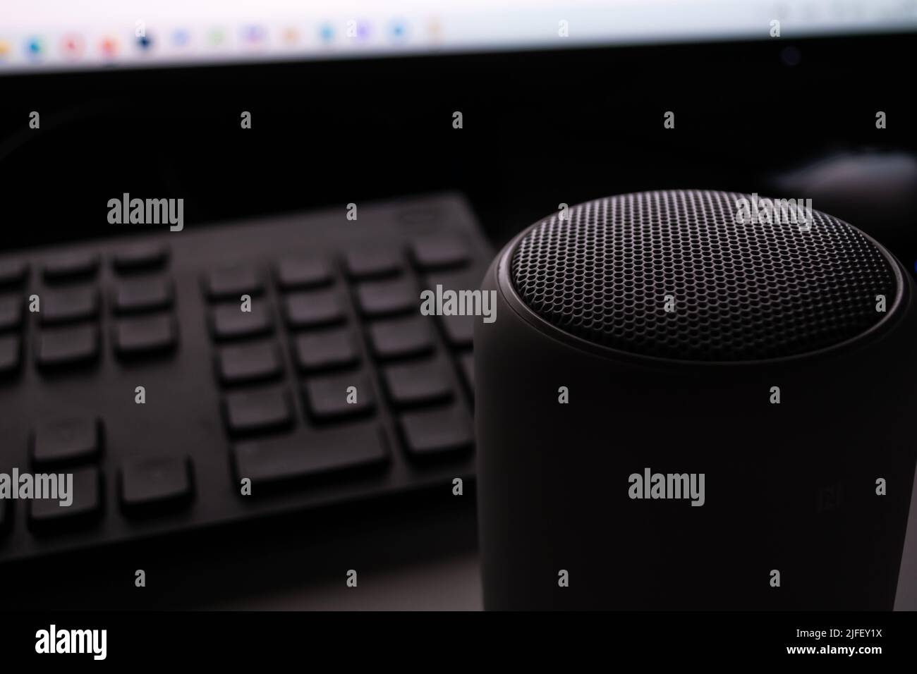Music column on the background of a computer and keyboard. Dark ...