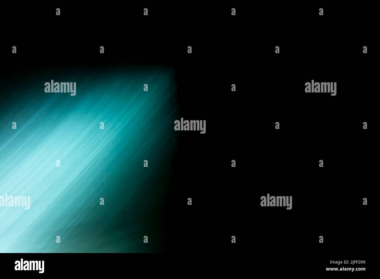 Abstract light in the dark. Black background with a blue white ray ...