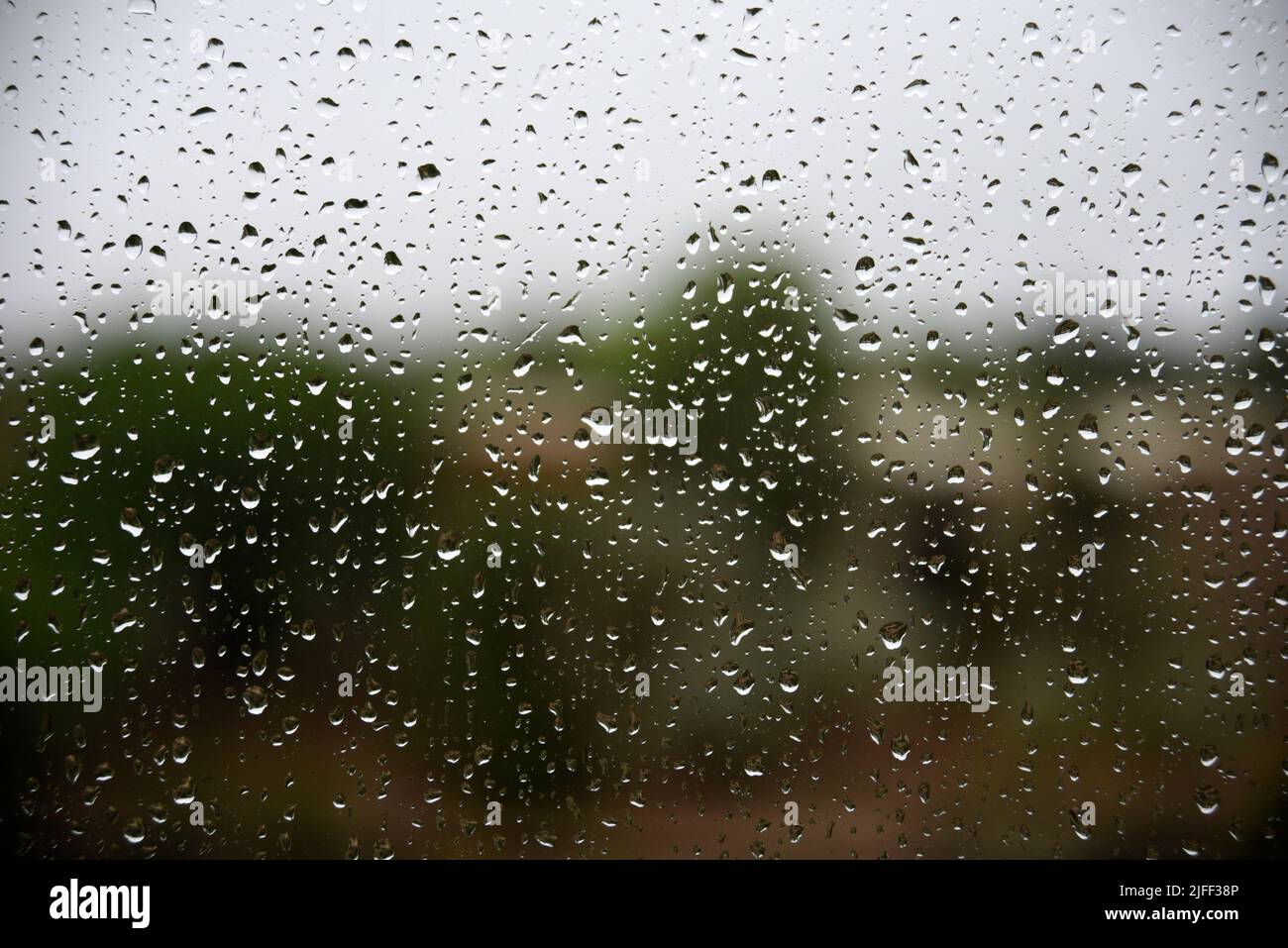 Raindrops run down a window pane after a monsoon storm passes through Santa Fe, New Mexico Stock ...