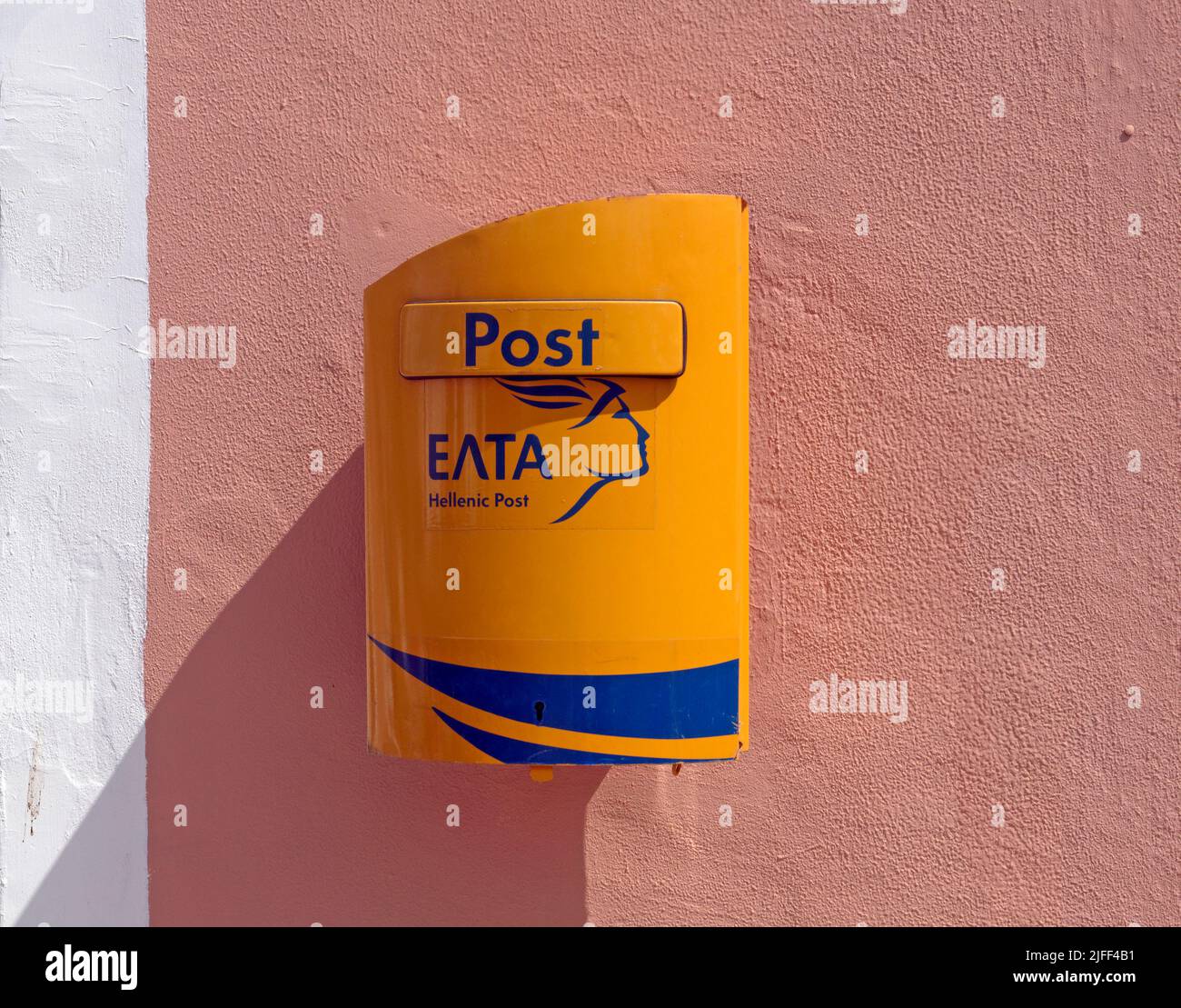 Greek yellow Hellenic Post post box on a pink wall Stock Photo - Alamy