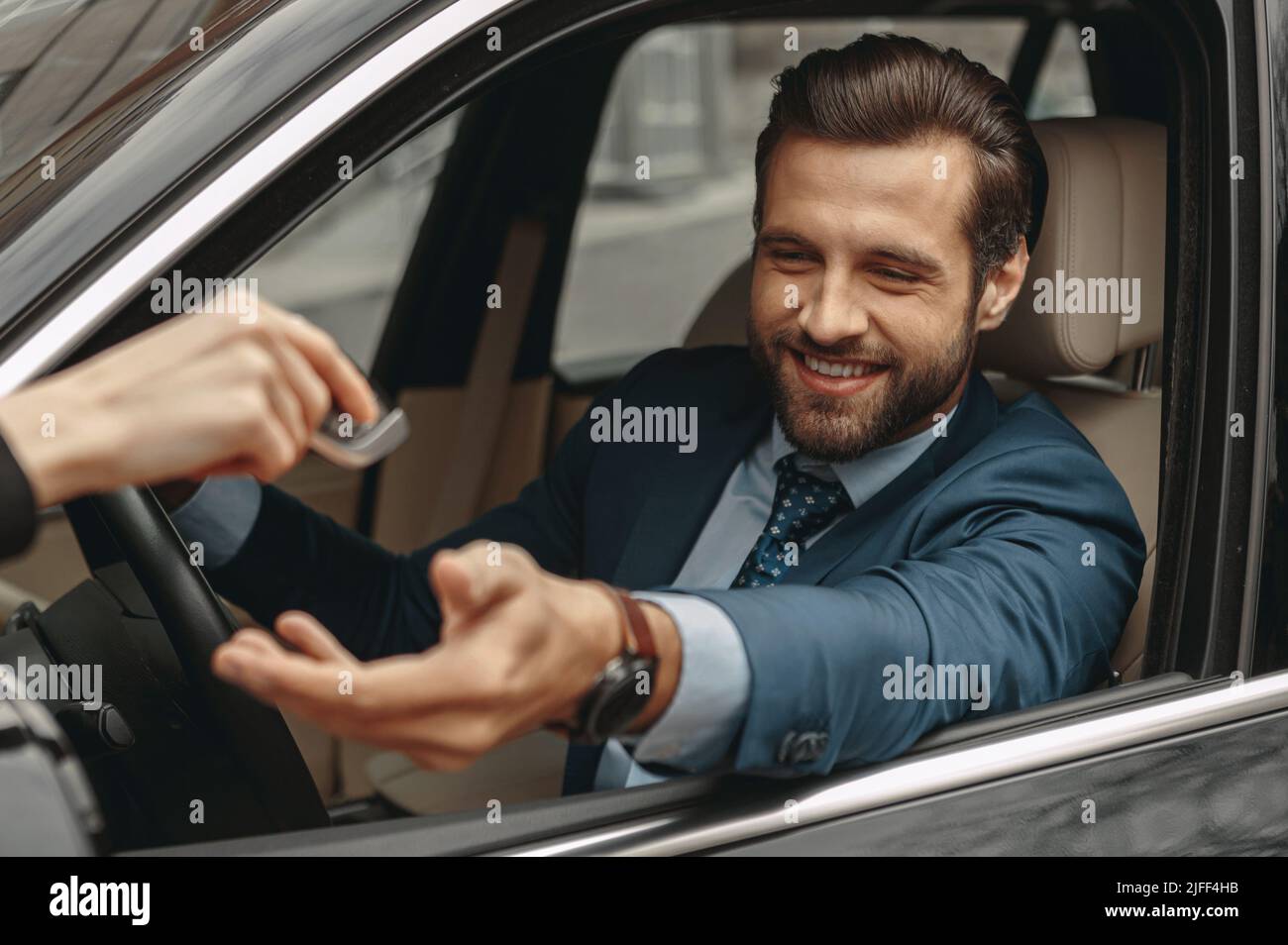 Happy young man getting keys hi-res stock photography and images - Alamy