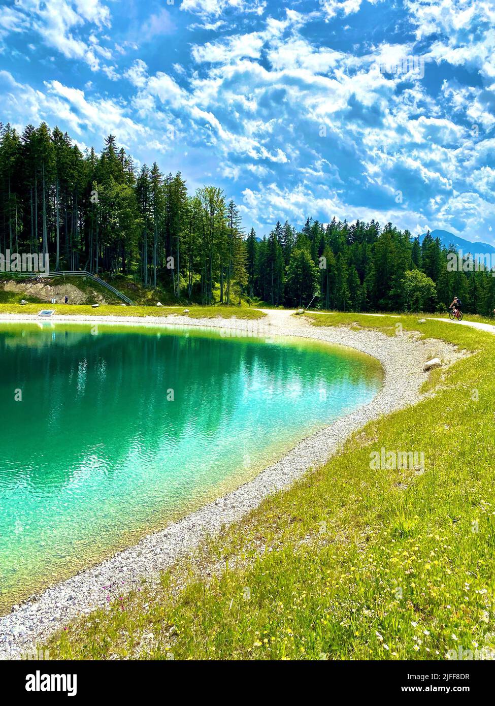 A vertical shot of a small lake with trees in the background Stock ...