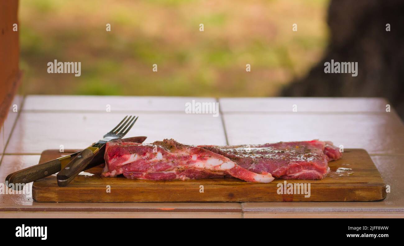 Large piece of raw red meat ready to be grilled. Typical argentinian ...