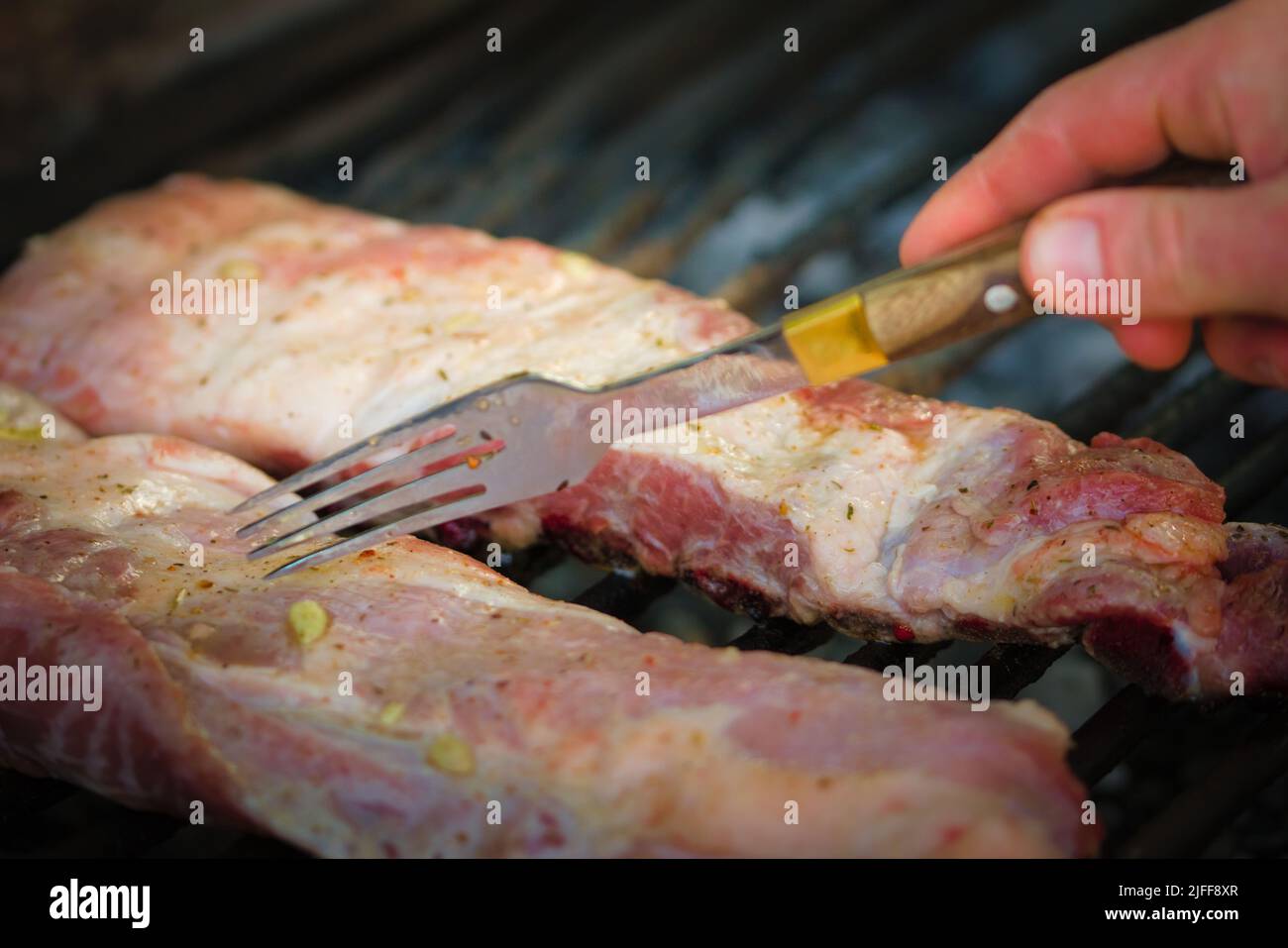 Large piece of red meat on the grill. Typical argentinian food, asado ...
