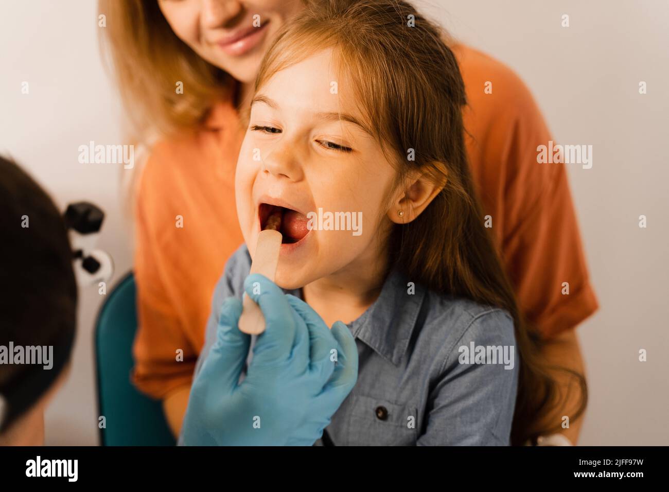Oropharyngoscopy procedure for child. Otolaryngologist examines child ...