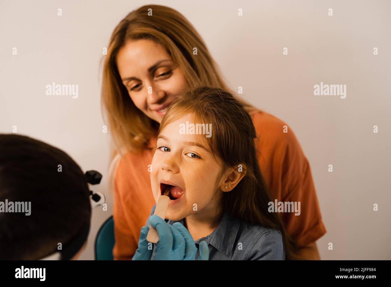 Oropharyngoscopy procedure for child. Otolaryngologist examines child ...