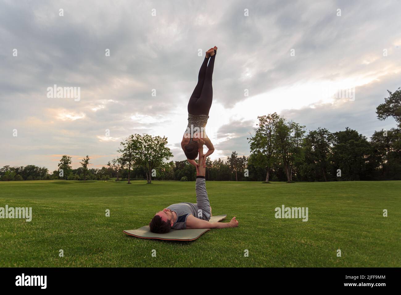 Strong acrobatic woman lifting man hi-res stock photography and images ...