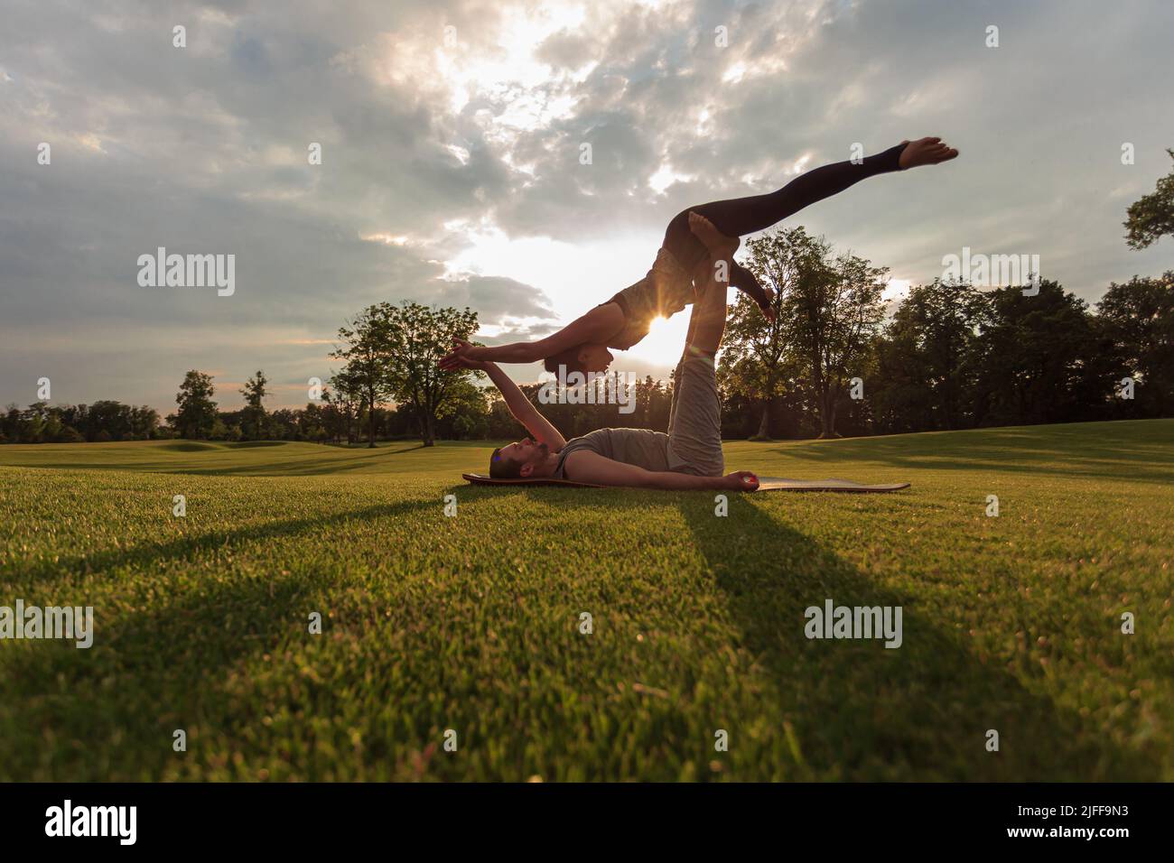 Strong acrobatic woman lifting man hi-res stock photography and images ...