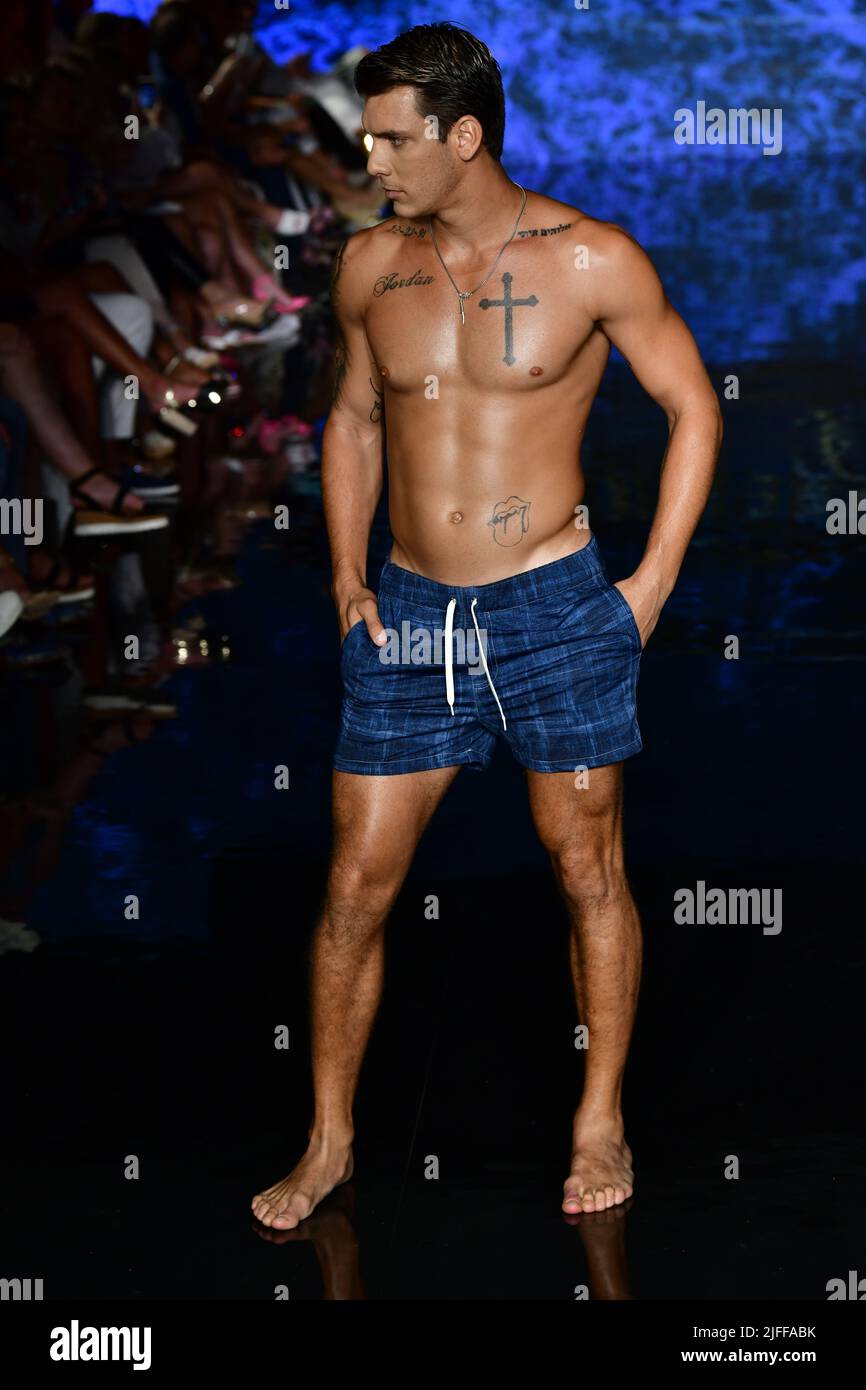 MIAMI BEACH, FLORIDA - JULY 09: A model walks the runway at the ...