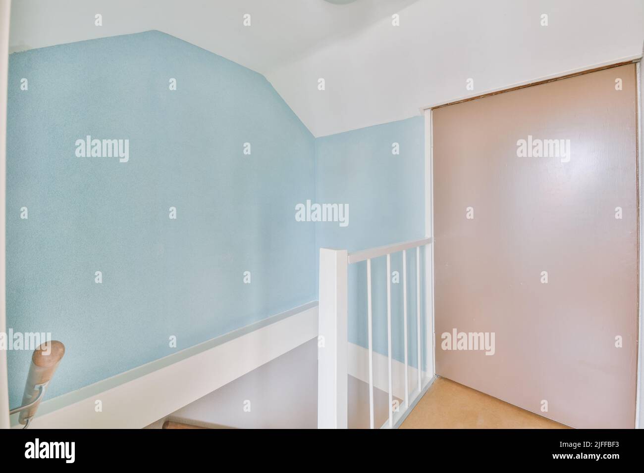 Hallay with blue and pink walls and white stairs leading down Stock ...
