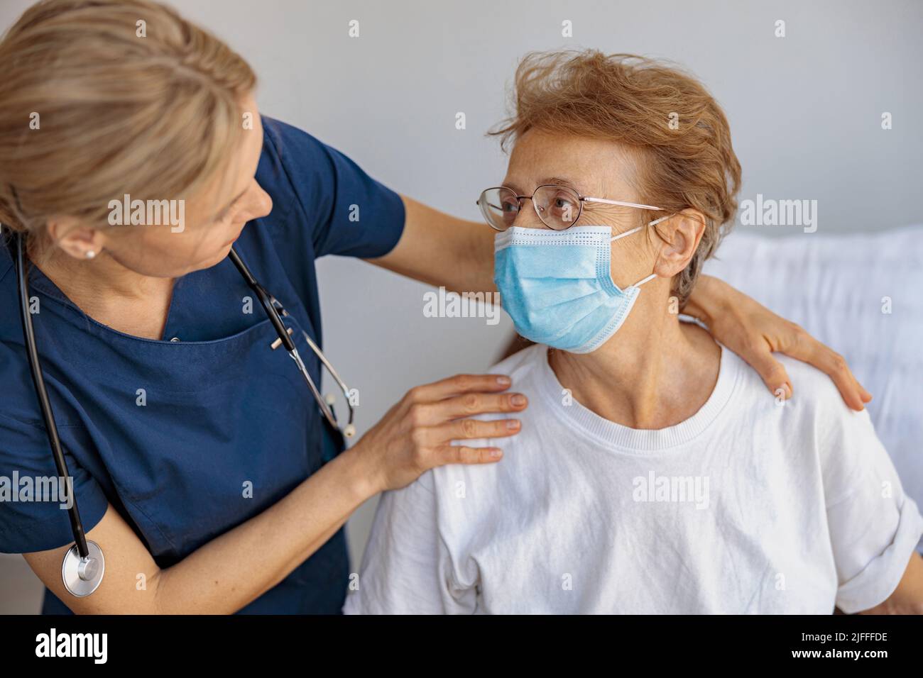 Doctor supporting a sick patient before medical procedures in a ...