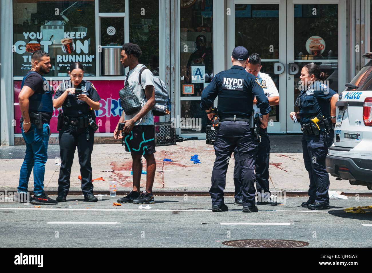 July 2, 2022: NYPD officers speak with a member of the public in front ...