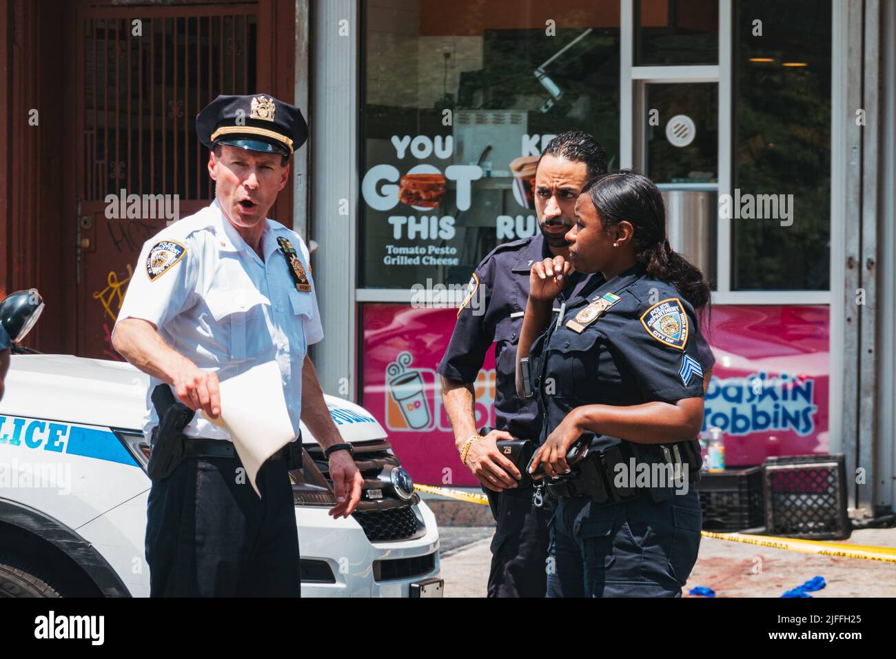 July 2, 2022: an NYPD commander speaks with officers in front of the ...