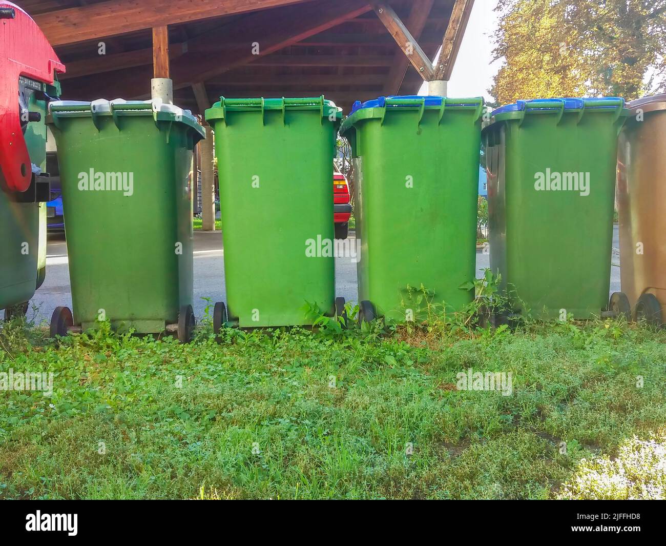 Garbage cans in different colors for waste management, trash recycling ...