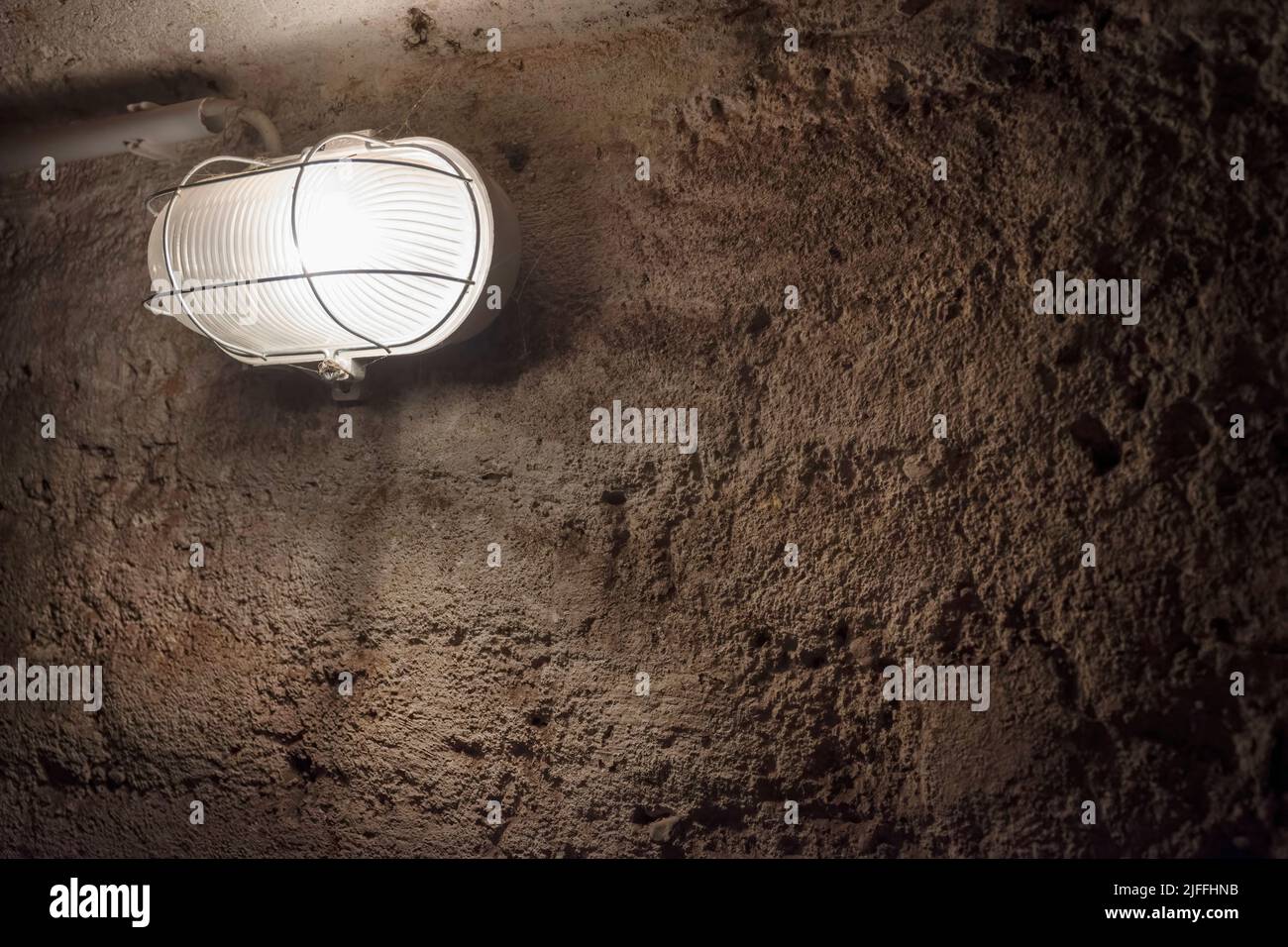 Concrete wall under Industrial old ceiling lamp light. Old vintage ...