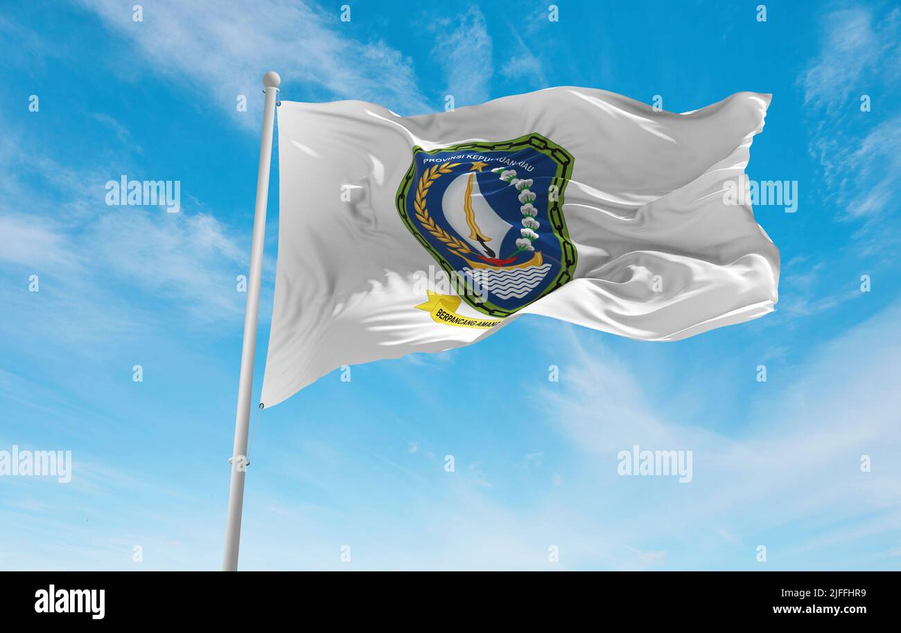 official flag of Riau Islands Indonesia at cloudy sky background on ...