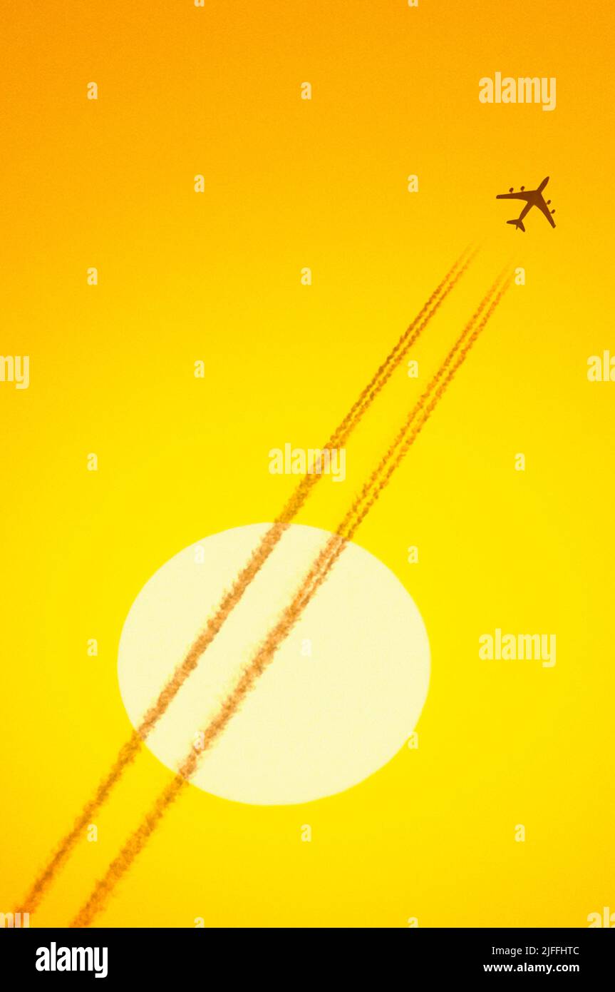 Jet, contrails and the sun Stock Photo - Alamy